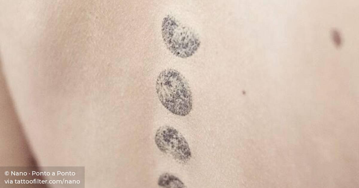Hand poked moon phase tattoos on the upper back.