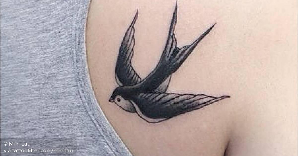Swallow tattoo on the right shoulder blade.