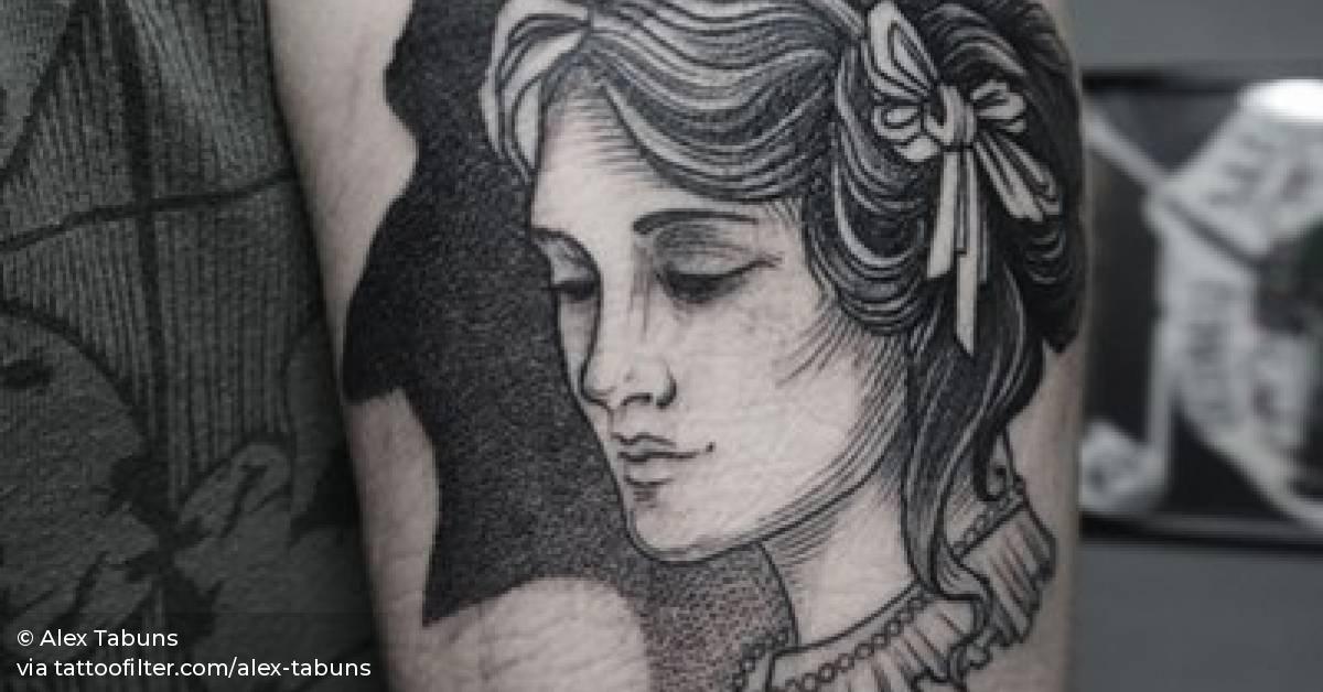 Woman with devil shadow tattoo on the left upper arm.