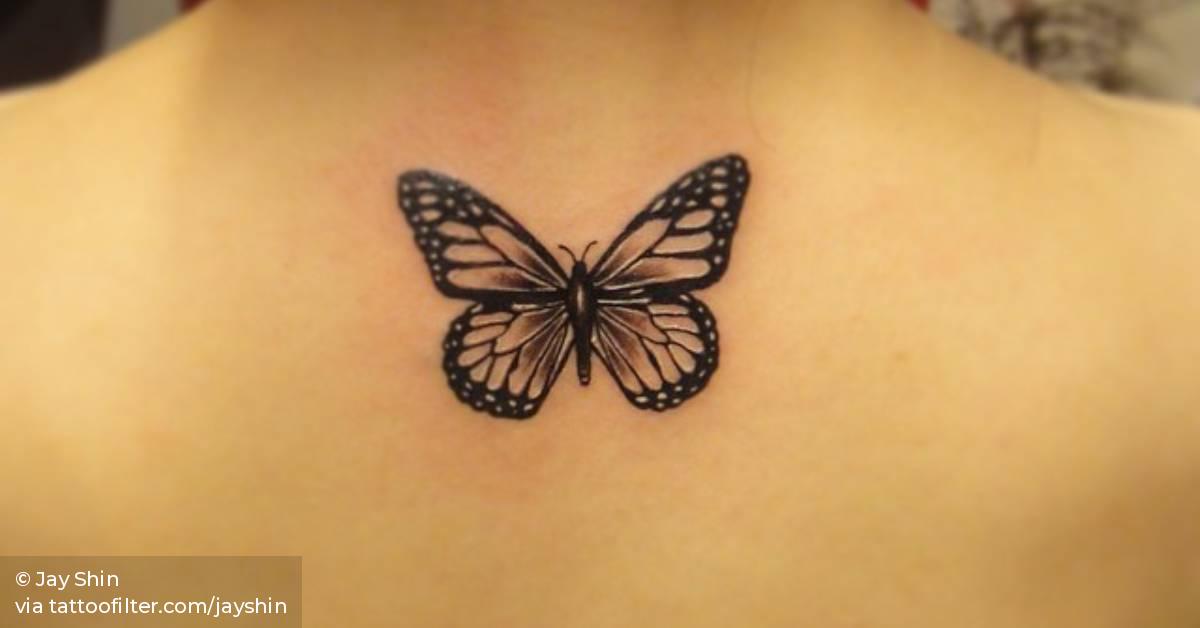 Upper back tattoo of a butterfly by Jay Shin.