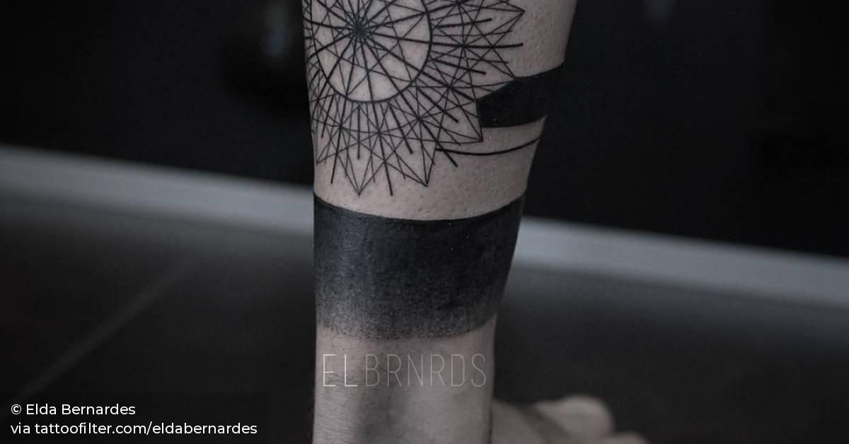 Geometric/blackwork style piece on the right leg.