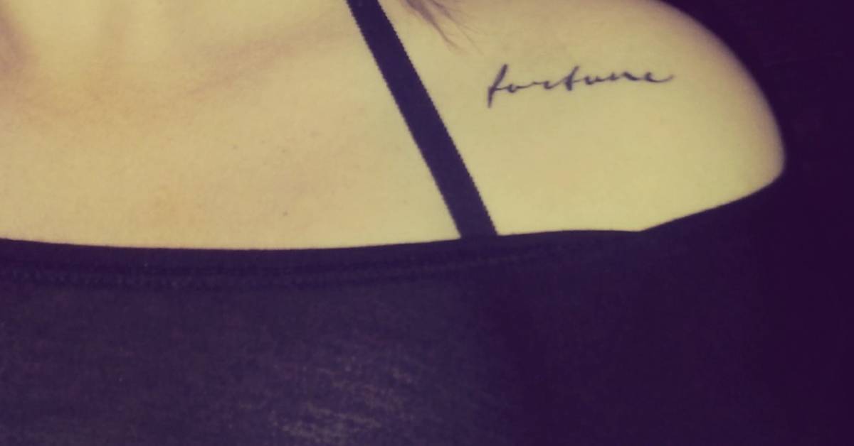 Shoulder tattoo saying "Fortune".
