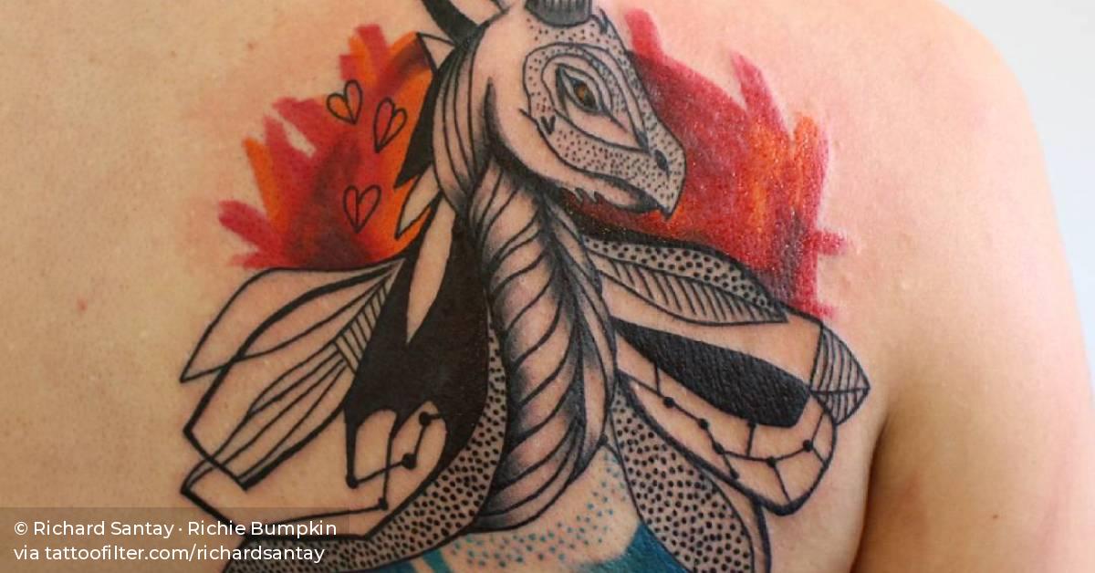 Abstract style dragon tattoo on the right shoulder