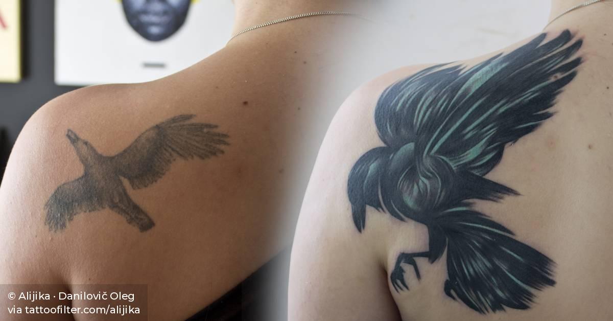 Acrylic style raven cover up tattoo on the left